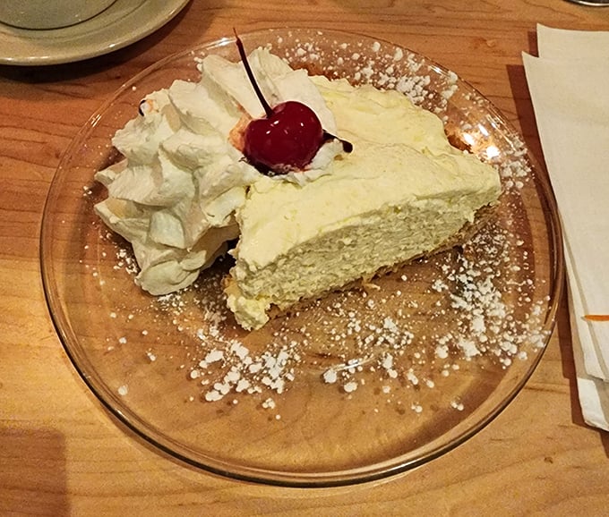 A slice of coconut cream pie that would make your grandmother both proud and jealous. That cherry on top isn't garnish—it's the exclamation point.