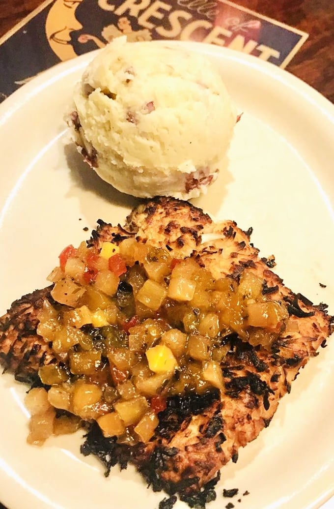 Coconut-crusted mahi-mahi with tropical salsa and a scoop of heaven—proof that sometimes the best vacation souvenirs are flavor memories.