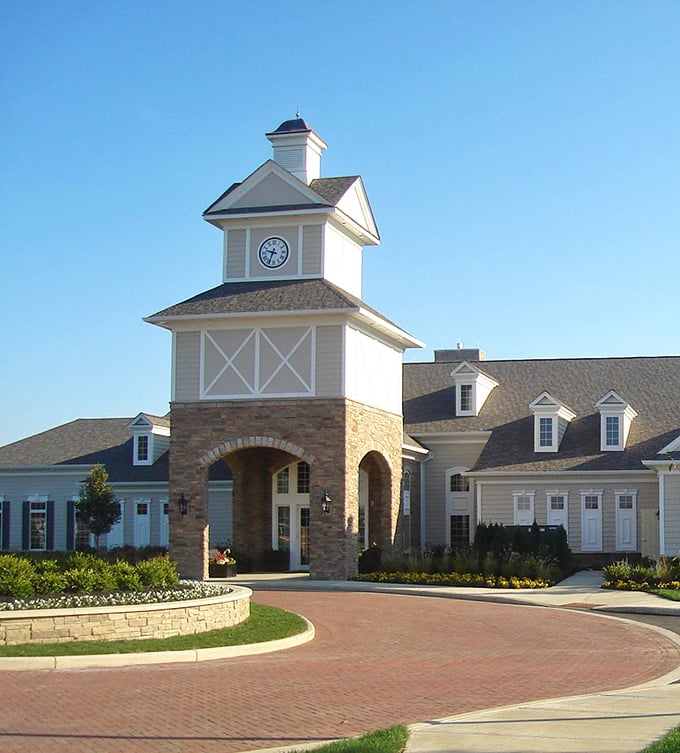 The clock tower community center stands as both architectural centerpiece and social hub—where retirement dreams come with brick-paved driveways.