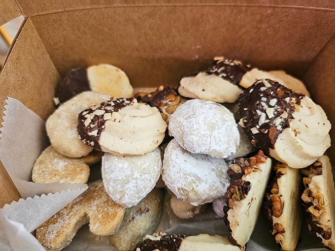 Cookie box paradise – where powdered sugar snowballs and chocolate-dipped delights coexist in perfect harmony. Resistance is both futile and unnecessary.