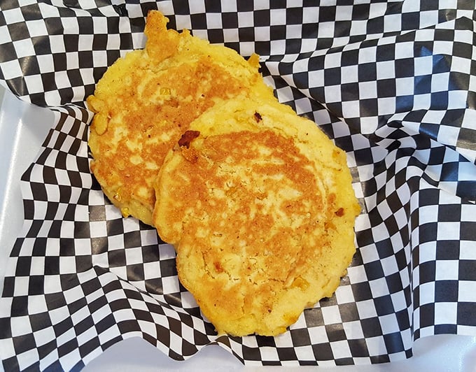 These golden corn fritters aren't just breakfast – they're edible sunshine that somehow made it onto a plate.
