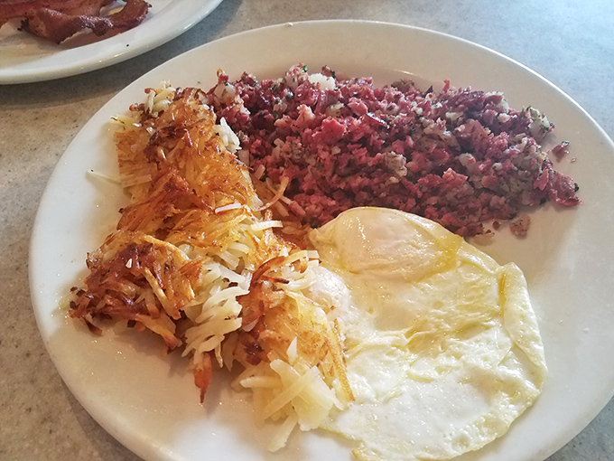 Corned beef hash with eggs and hash browns – the breakfast trinity that's converted more people than Sunday sermons. That crispy edge is pure salvation.