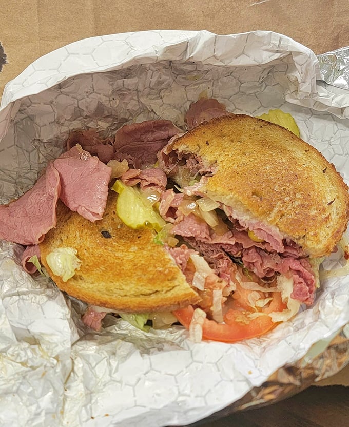 This isn't just a sandwich; it's a masterpiece of corned beef architecture. Every bite delivers the perfect ratio of meat, bread, and toppings.
