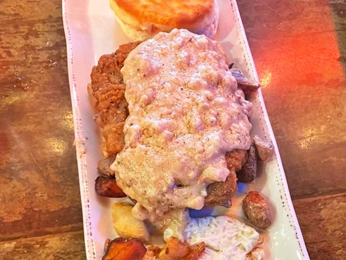 Country fried steak swimming in creamy gravy atop a bed of potatoes—Southern comfort that sticks to your ribs and soothes your soul.
