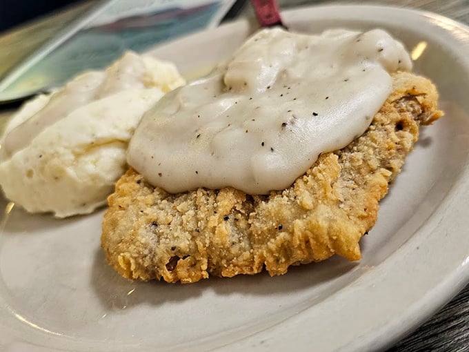 Country fried steak smothered in gravy – where crispy exterior meets tender interior in a dance as old as time itself.