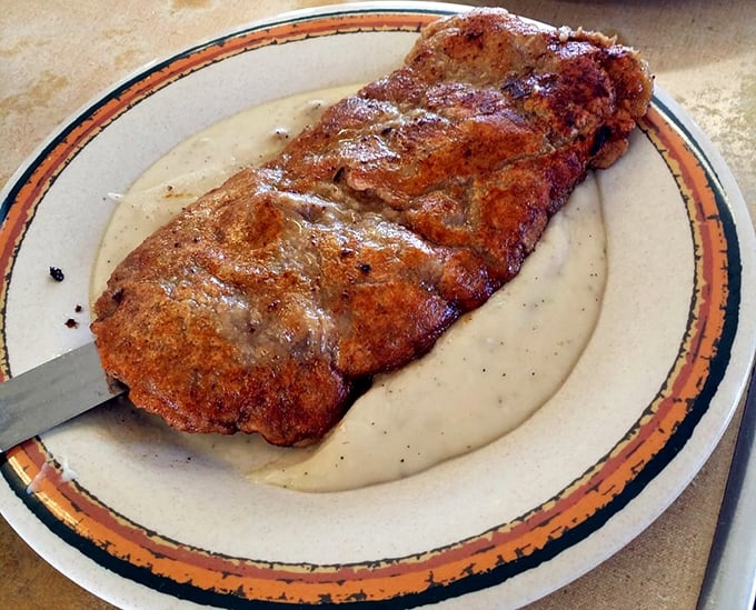Country fried steak that's traveled through time from your grandmother's kitchen – crispy, hearty, and unapologetically comforting.