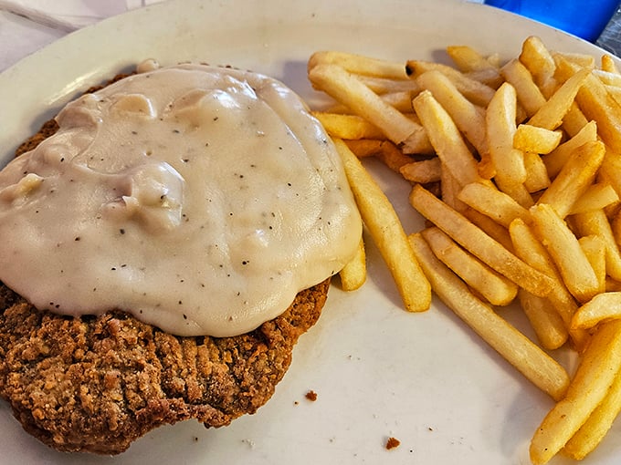 Country fried steak smothered in gravy that could solve international conflicts. Paired with golden fries that somehow maintain their crispness despite the delicious onslaught.
