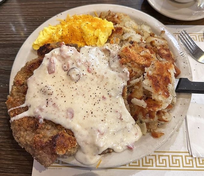Country fried steak – where a humble cut of beef transforms into something transcendent under a blanket of peppery gravy. This is breakfast as an art form.