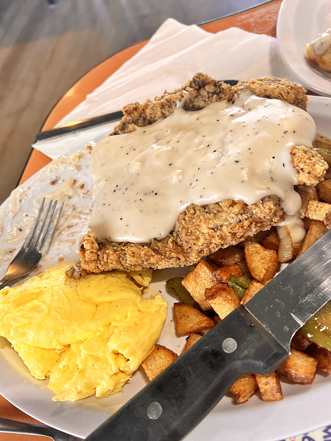 Country fried steak smothered in gravy alongside golden eggs—the breakfast equivalent of a warm hug from your favorite aunt.