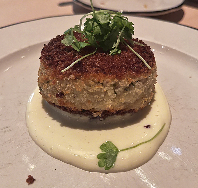 This crab cake doesn't hide behind fillers—it's the seafood equivalent of showing up to a party with nothing to prove.