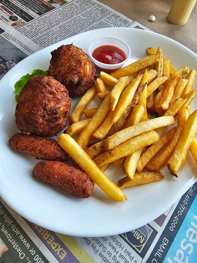 Golden-brown crab cakes that are more crab than cake—the way nature intended—served with crispy fries that could make a potato proud.
