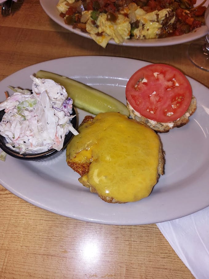 A sandwich that demands both hands and your full attention—melty cheese, fresh tomato, and coleslaw that doesn't apologize for being exactly what it is.
