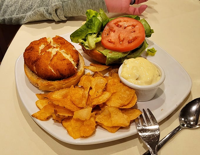 A golden-brown crab cake sandwich that doesn't hide behind fillers – just pure Maryland-style crab meat ready for its close-up.