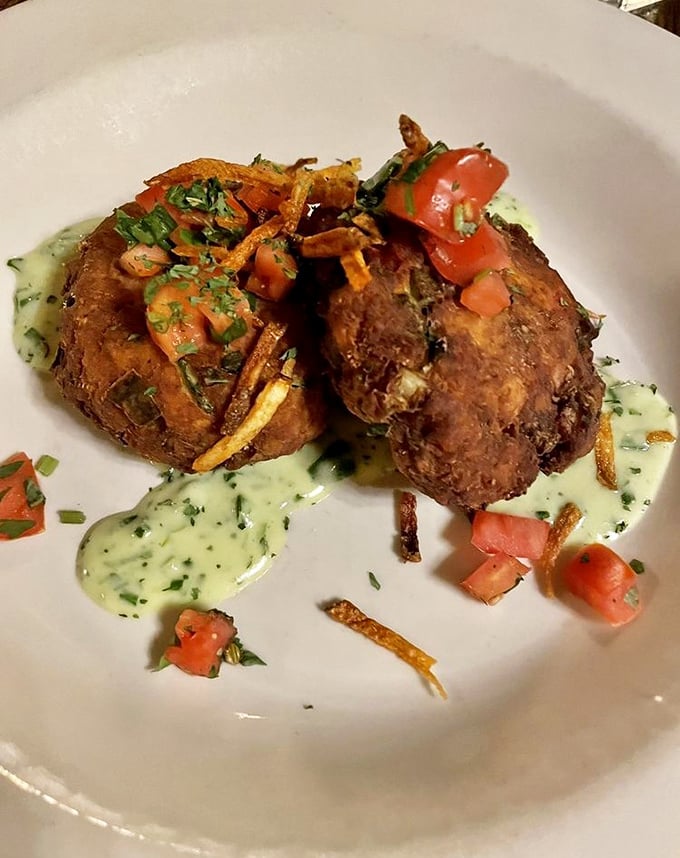 These crab cakes aren't playing around – crispy exterior giving way to succulent meat, all swimming in a herb-flecked sauce that deserves a standing ovation.