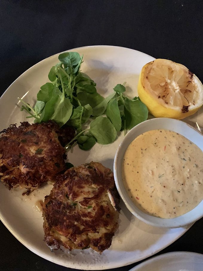 These crab cakes aren't just appetizers—they're little islands of seafood bliss, served with a sauce that deserves its own fan club.