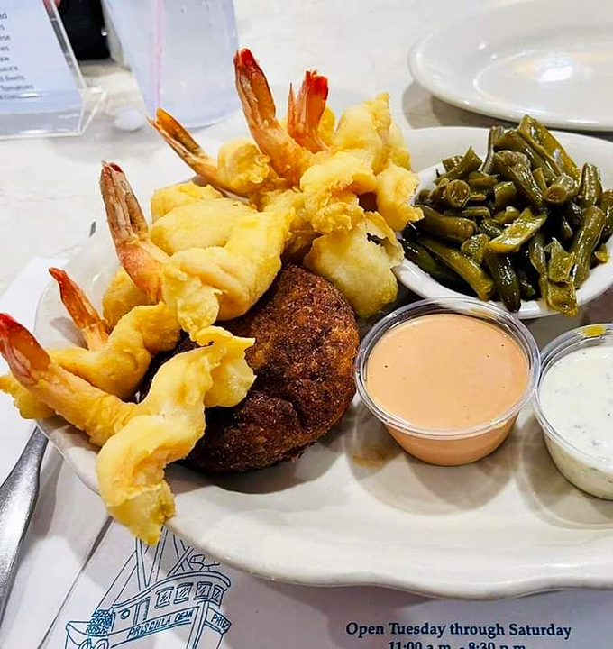 A plate that speaks the universal language of "yum." Plump shrimp, a golden crab cake, and fresh sides—Florida's coastal bounty on display.