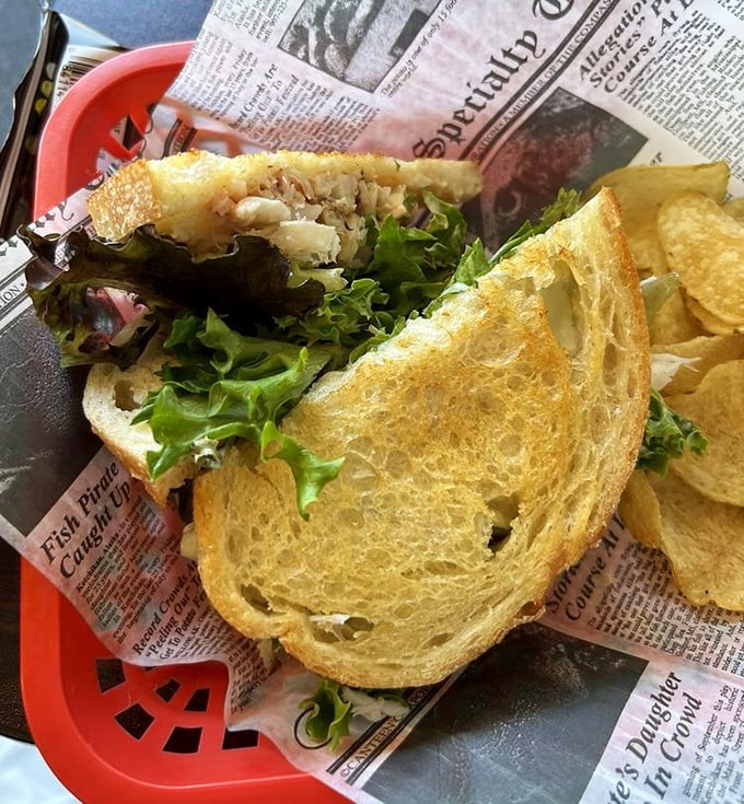Sandwich architecture at its finest. Golden toasted bread barely containing a generous heap of sweet crab meat—a handheld masterpiece of coastal cuisine.