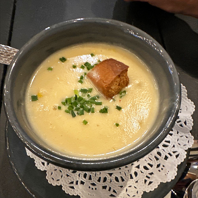The legendary crab bisque in all its glory. Velvety, rich, and worth every mile of the drive. This isn't soup – it's liquid gold.