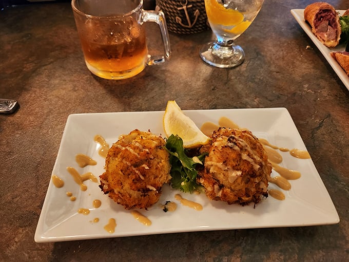 Golden-brown crab cakes that are all meat and no filler—the holy grail of seafood appetizers. That drizzle of remoulade sauce is just showing off.