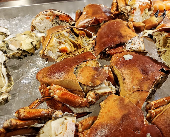 Dungeness crab sections glisten on ice, their sweet meat waiting to reward those willing to put in the delightful work of extraction.