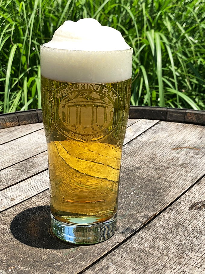 A perfect pour with the brewpub's logo proudly displayed—this beer isn't just photogenic, it's practically auditioning for its own reality show.