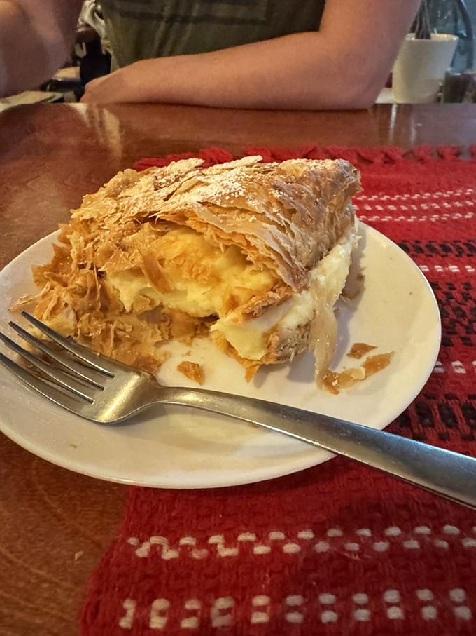 This cream-filled pastry isn't just dessert—it's architecture. Flaky layers collapse with each forkful, creating a sweet avalanche worth every calorie.