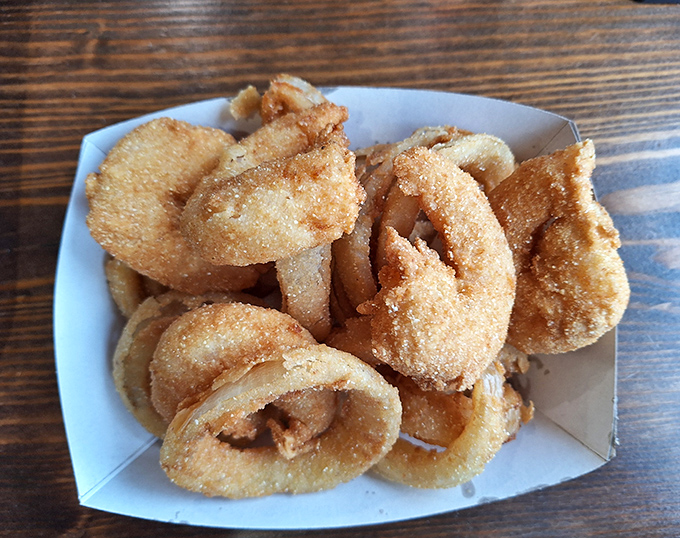 Crispy, golden onion rings that achieve that perfect crunch-to-tenderness ratio – the kind that make you wonder why you don't order them more often.