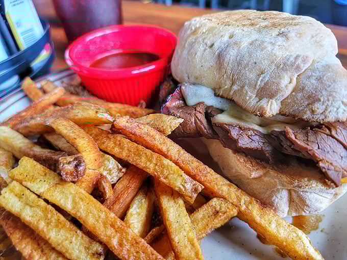 The French dip arrives like a meaty revelation—tender beef, crusty bread, and that magical au jus for dipping that makes you wonder why all sandwiches don't come with sauce.