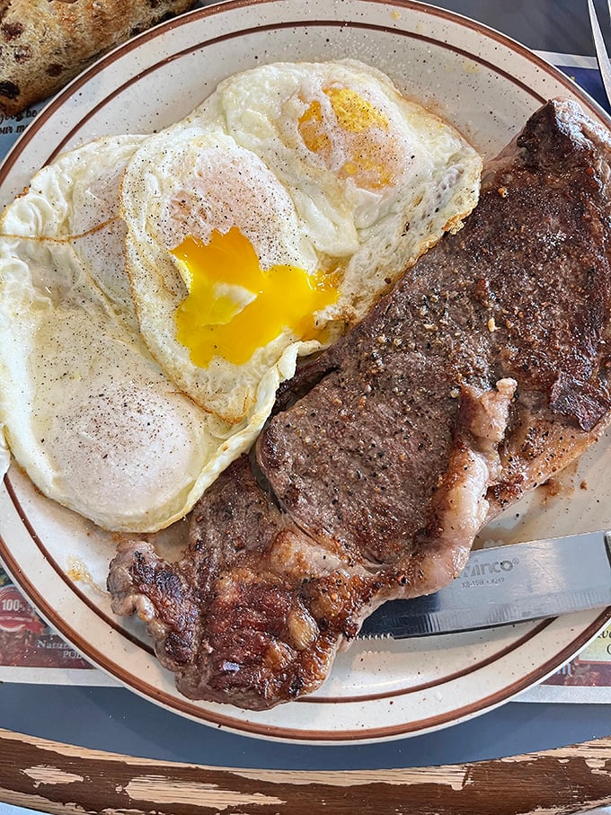 The classic steak and eggs—where a perfectly runny yolk creates nature's most perfect sauce for that seasoned ribeye.