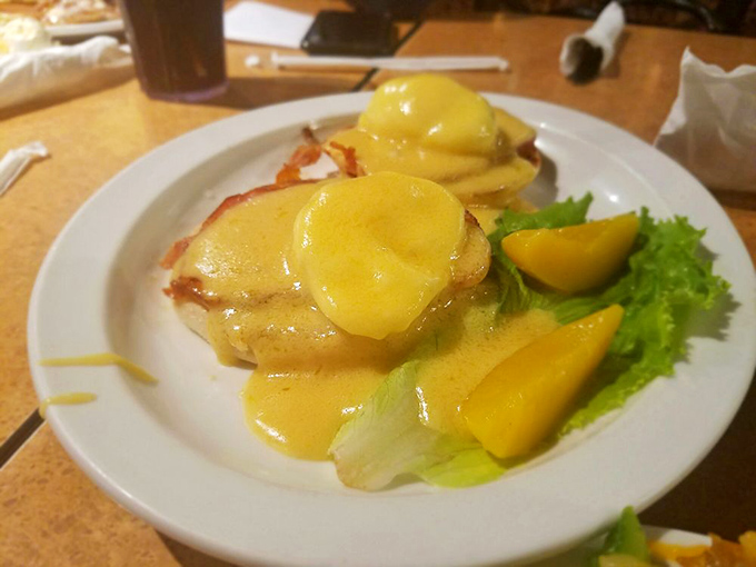 Eggs Benedict done right: English muffins supporting Canadian bacon and poached eggs, all swimming in hollandaise that's sunshine on a plate.