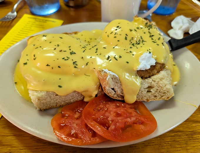 Hollandaise sauce cascading down like a yellow waterfall—this eggs benedict doesn't just satisfy hunger, it creates memories that linger longer than your suntan.