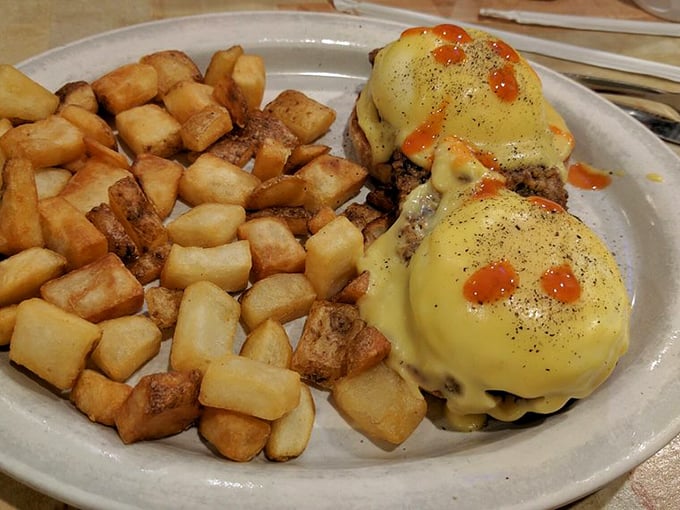 Eggs Benedict done right – where hollandaise sauce cascades down like a yellow waterfall of buttery goodness.