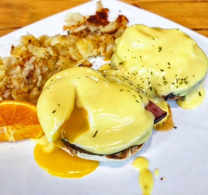 Eggs Benedict that makes you understand why people wait in line—hollandaise sauce flowing like liquid gold over perfectly poached eggs.