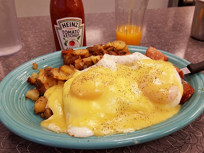 Hollandaise cascading over poached eggs like a golden waterfall—this Eggs Benedict isn't just breakfast, it's performance art.