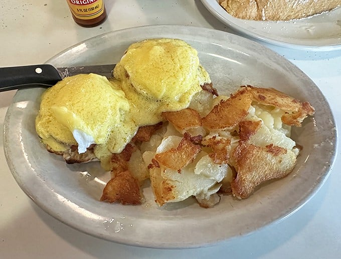 Eggs Benedict done right—golden hollandaise cascading over perfectly poached eggs. Breakfast doesn't get more beautiful than this.