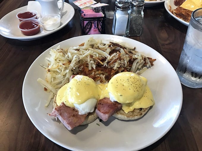 Benedict perfection: poached eggs perched atop their English muffin thrones, crowned with hollandaise that cascades down like a royal robe.