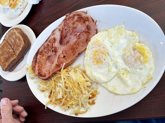 The classic breakfast trinity – perfectly cooked eggs, ham with just the right sear, and hash browns crisped to golden perfection.