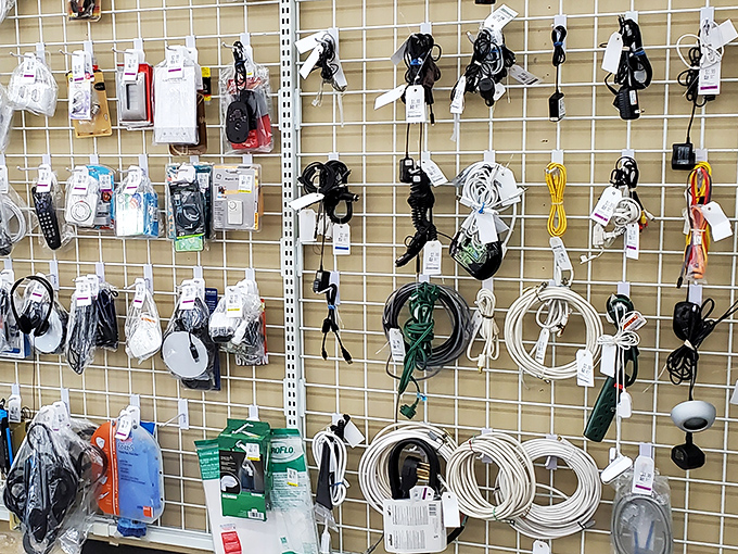 A wall of technological possibility—chargers, cables, and adapters that somehow multiply in everyone's junk drawer find new purpose here.