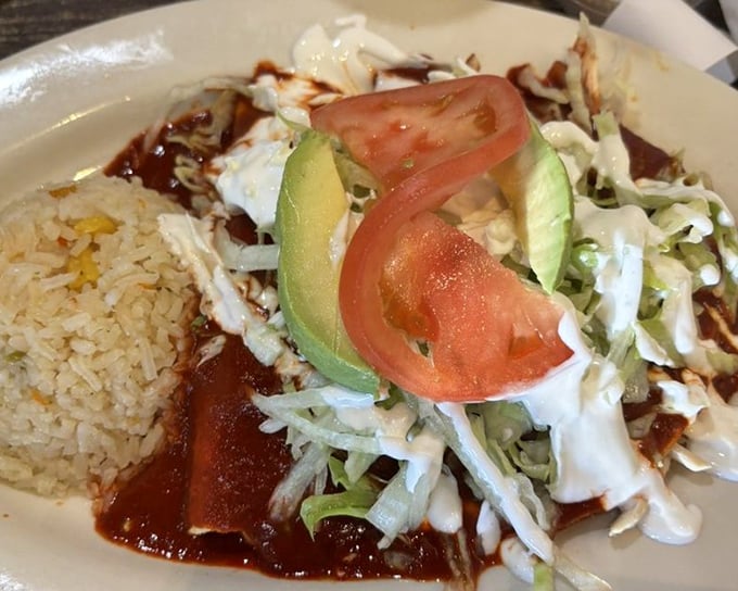 Enchiladas swimming in a vibrant sauce sea with islands of cheese and cilantro. The kind of plate that silences conversation immediately.