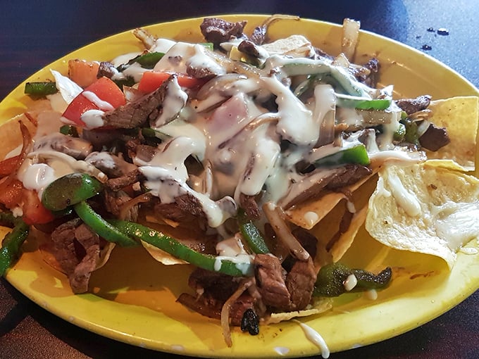 Steak fajita nachos that make sharing a moral dilemma—each chip loaded with enough toppings to qualify as its own mini-meal.