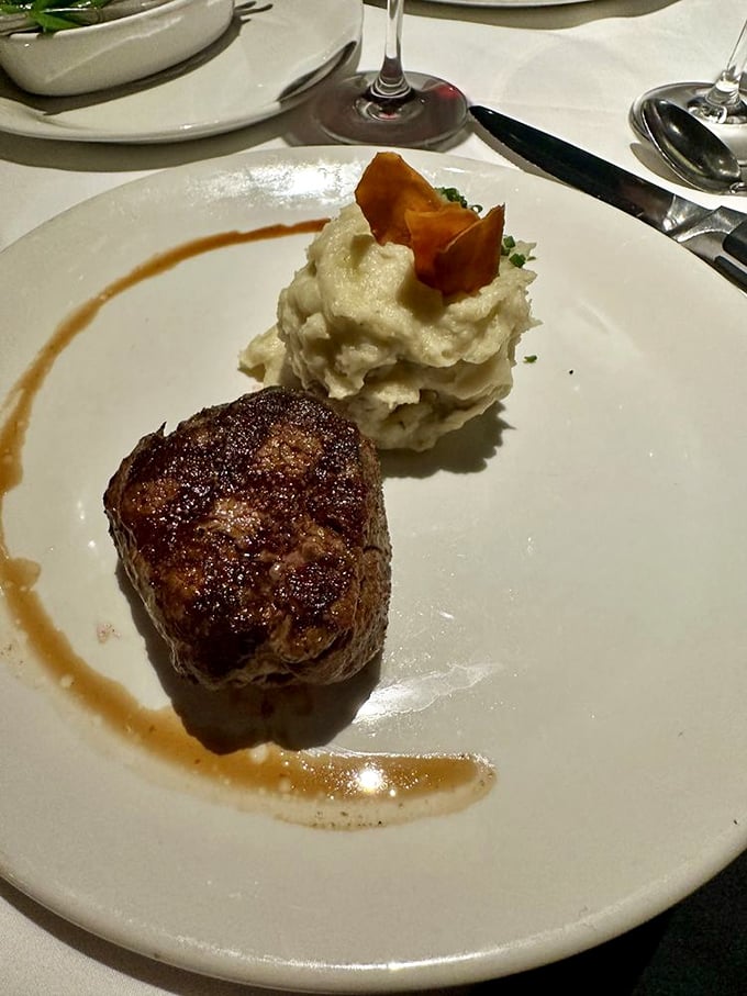 A filet mignon that's dressed for success, partnered with mashed potatoes so fluffy they could moonlight as clouds in their spare time.