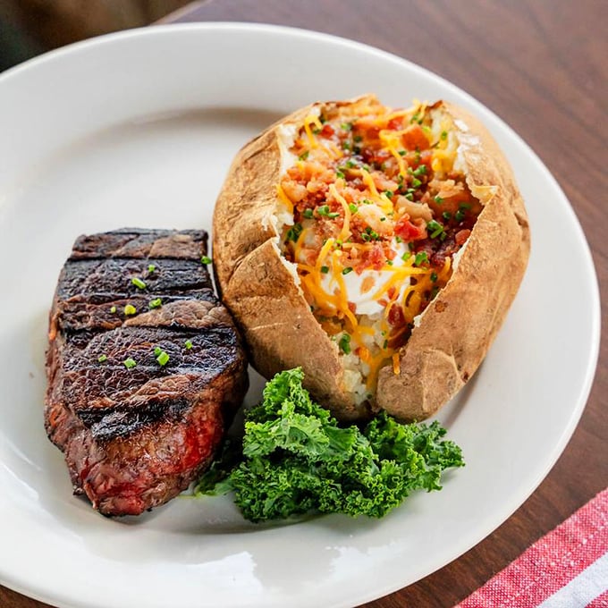 A perfectly seared filet mignon alongside a loaded baked potato – comfort food that's dressed for a night on the town.