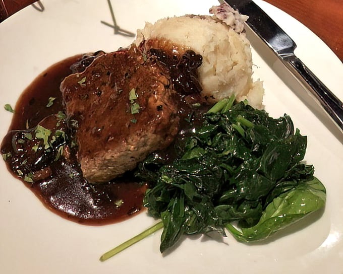 This isn't just meat and potatoes—it's a plate of nostalgia. Rich sauce pools around tender beef with greens for color (and conscience).