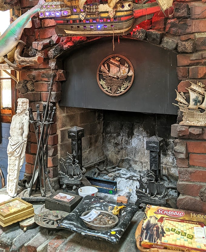 Even the fireplace tells stories, surrounded by nautical artifacts, vintage games, and the kind of brick-and-mortar charm Amazon can't replicate.