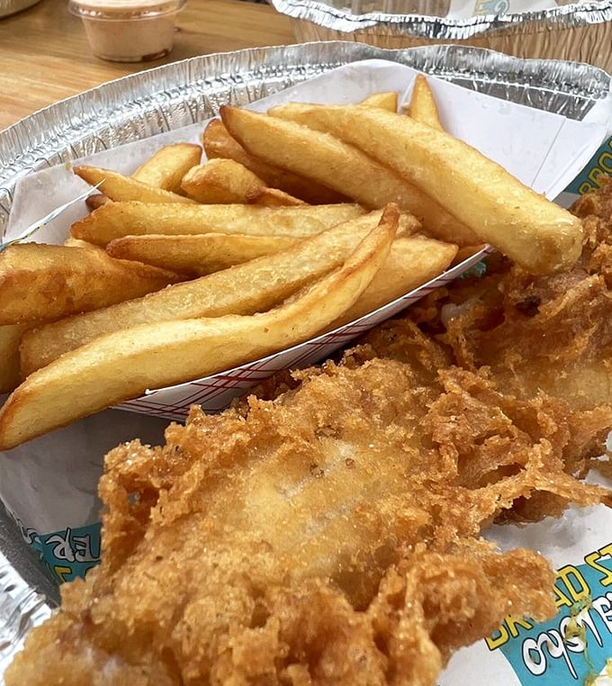 Golden-battered fish alongside perfectly crisp fries—proof that sometimes the classics become classics for a reason. The kind of dish that demands a sea breeze and cold beer.