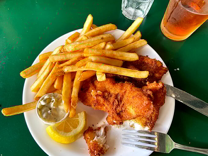 Fish and chips that would make a British pub jealous—golden armor protecting flaky white fish alongside fries that demand to be devoured.
