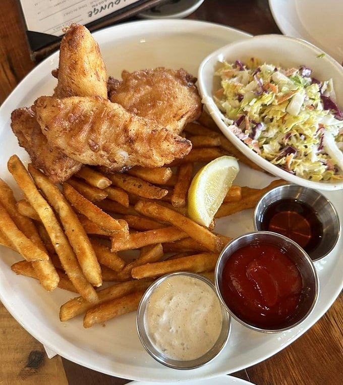 Fish and chips that would make the British weep with joy - golden, crispy batter protecting flaky white fish with three dipping sauces playing backup.