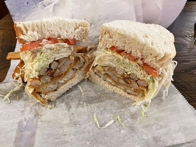 Two halves that make a whole lot of sense. This fish sandwich cross-section reveals the brilliant stratification of Primanti’s engineering marvel.