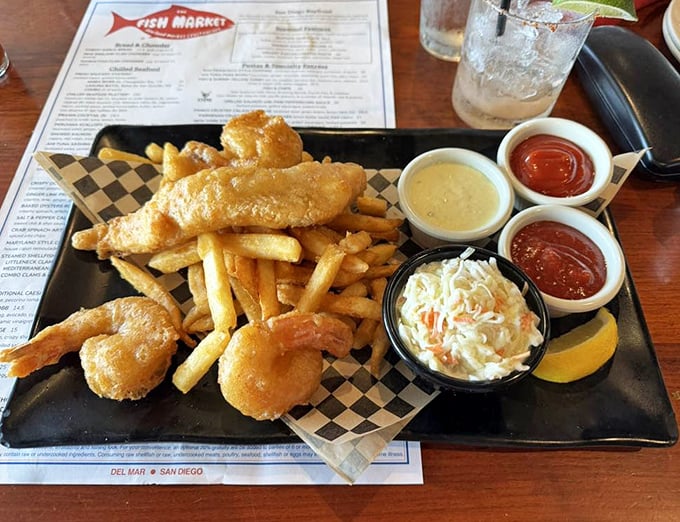 Fish and chips that would make a British pub regular weep with joy – golden-battered perfection with three dipping sauces because decisions are hard.