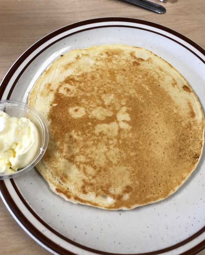 Pancakes so perfectly golden they could win medals, with a side of butter that's not apologizing for being exactly what you want.